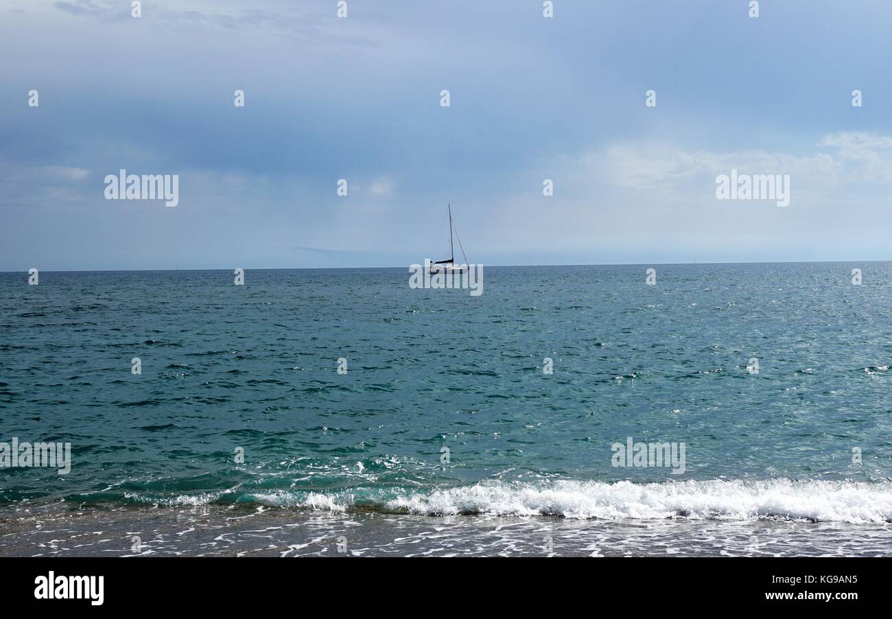Sailboat in ocean with waves Stock Photo - Alamy