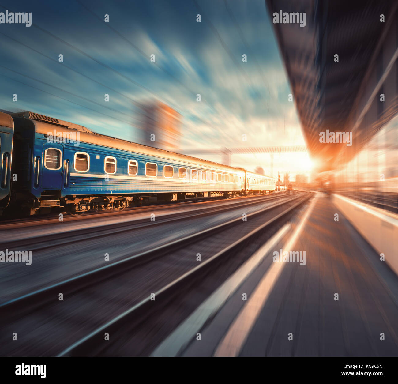 Beautiful train with blue wagons in motion at the railway station at ...