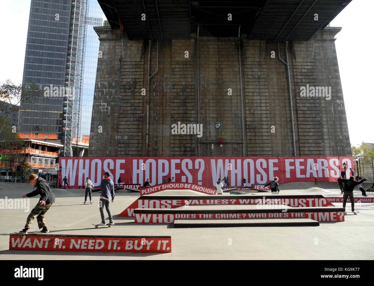 Skaters skate in a skatepark over ramps of a parcour adorned with edgy ...