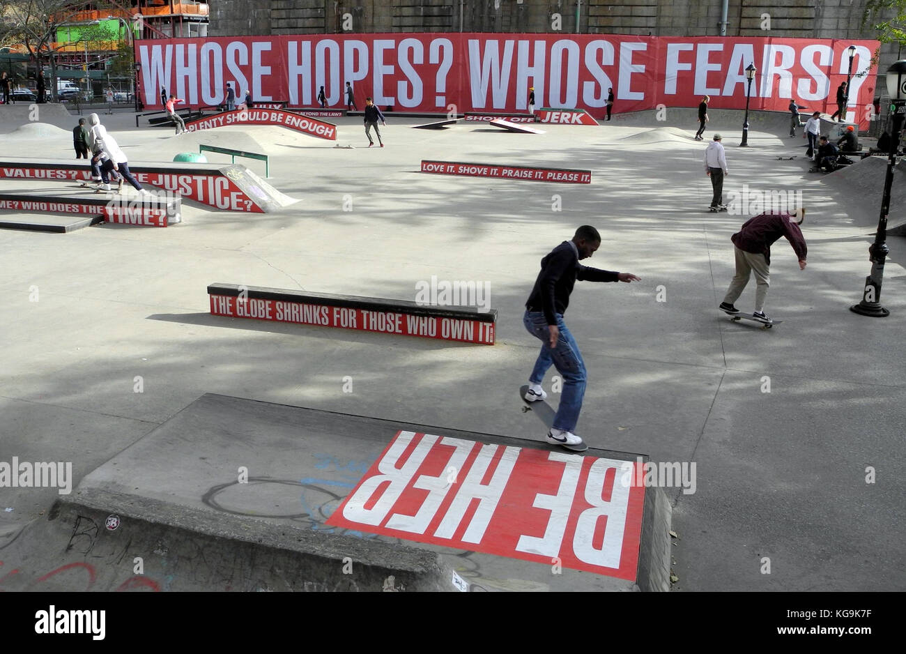 Skaters skate in a skatepark over ramps of a parcour adorned with edgy ...