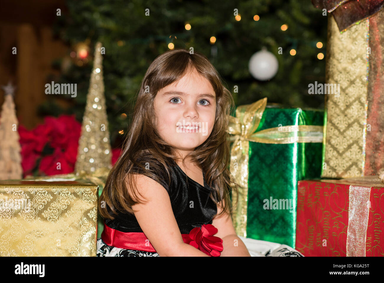 Little Girl with Christmas Tree, Presents & Lights Stock Photo - Alamy