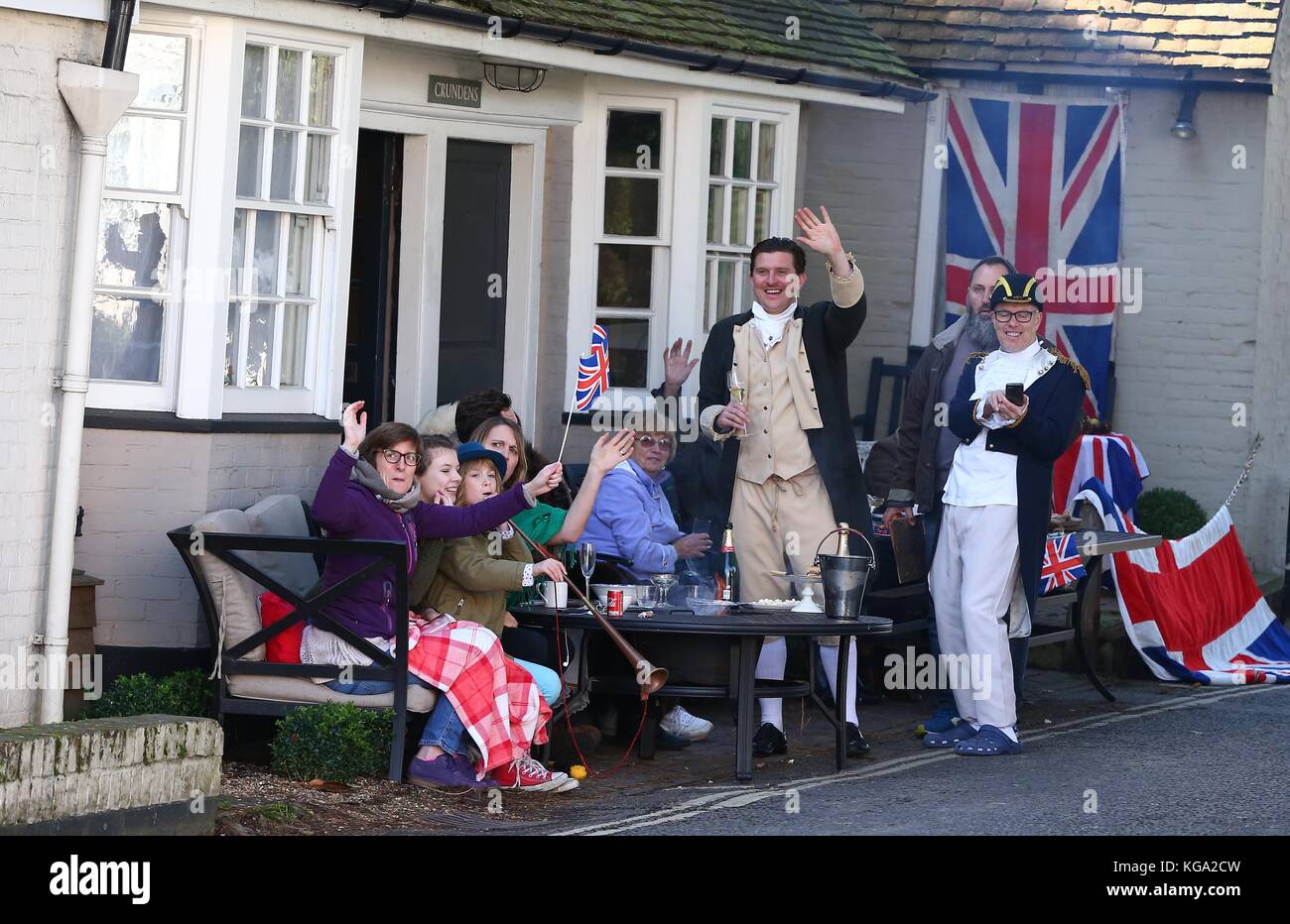 Spectators in vintage fancy dress wave on Competitors as they drive ...