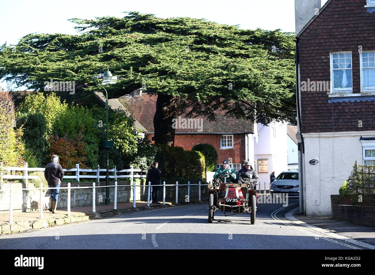 Competitors in the vintage automobiles drive through Cuckfield Village ...