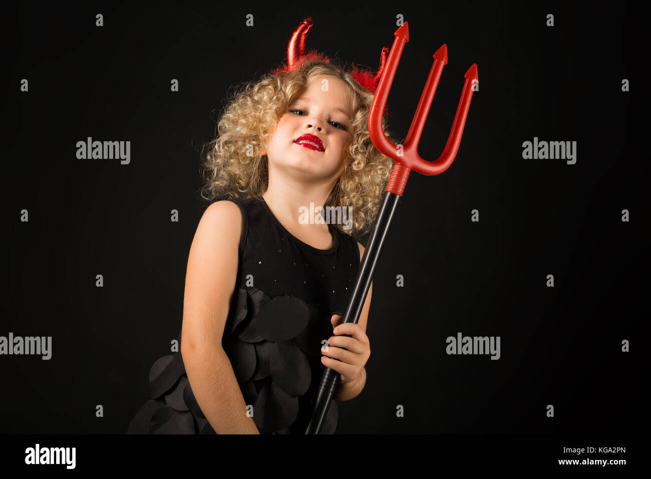 Cute girl in devil costume Stock Photo - Alamy