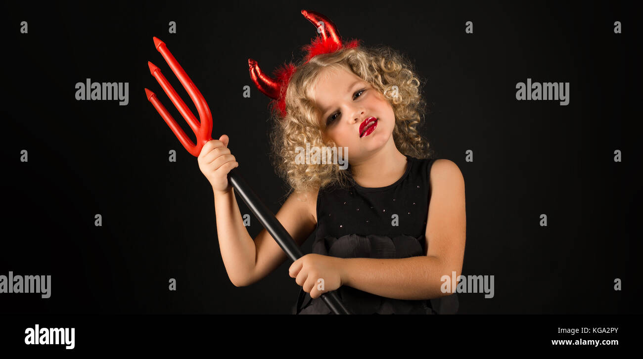 Cute girl in devil costume Stock Photo - Alamy