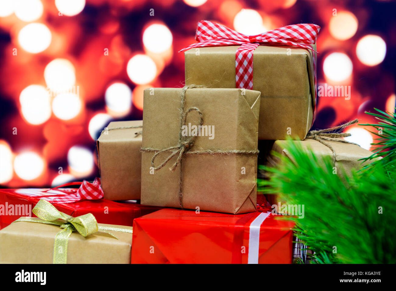Many gift boxes on xmas tree background Stock Photo - Alamy