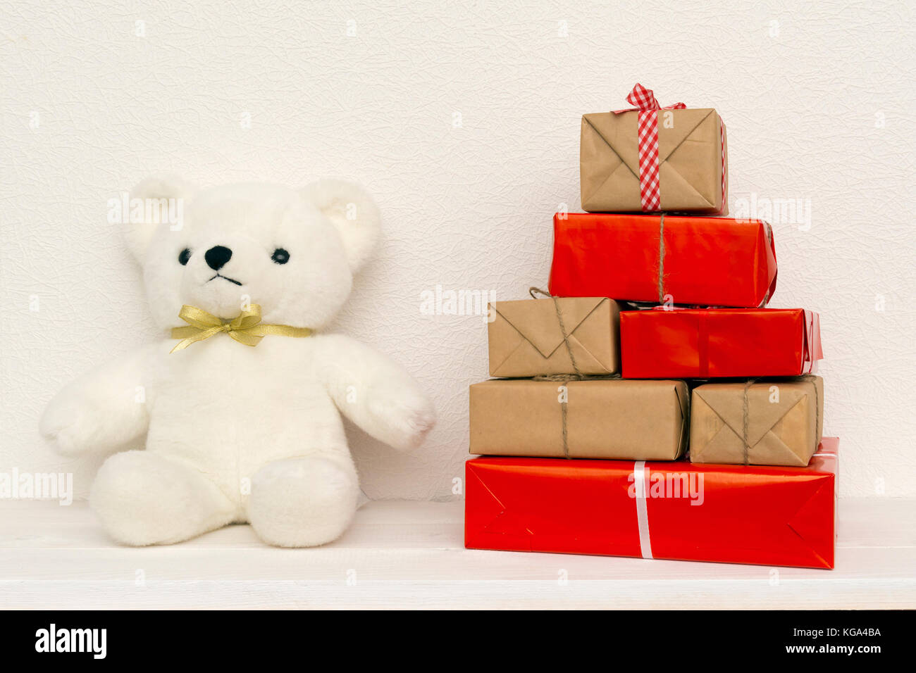 Bear doll with gift boxes on white background Stock Photo - Alamy