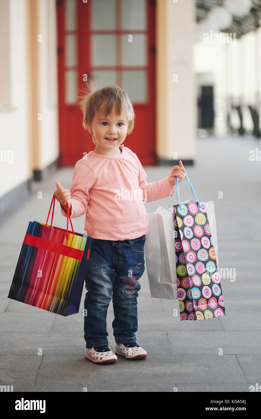 cute little girl with many shopping bags Stock Photo - Alamy
