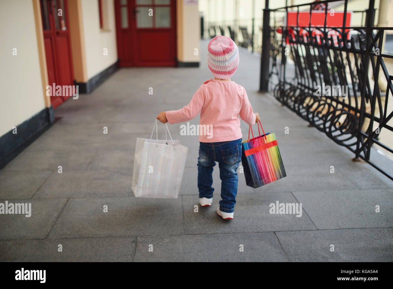 cute little girl with many shopping bags Stock Photo - Alamy