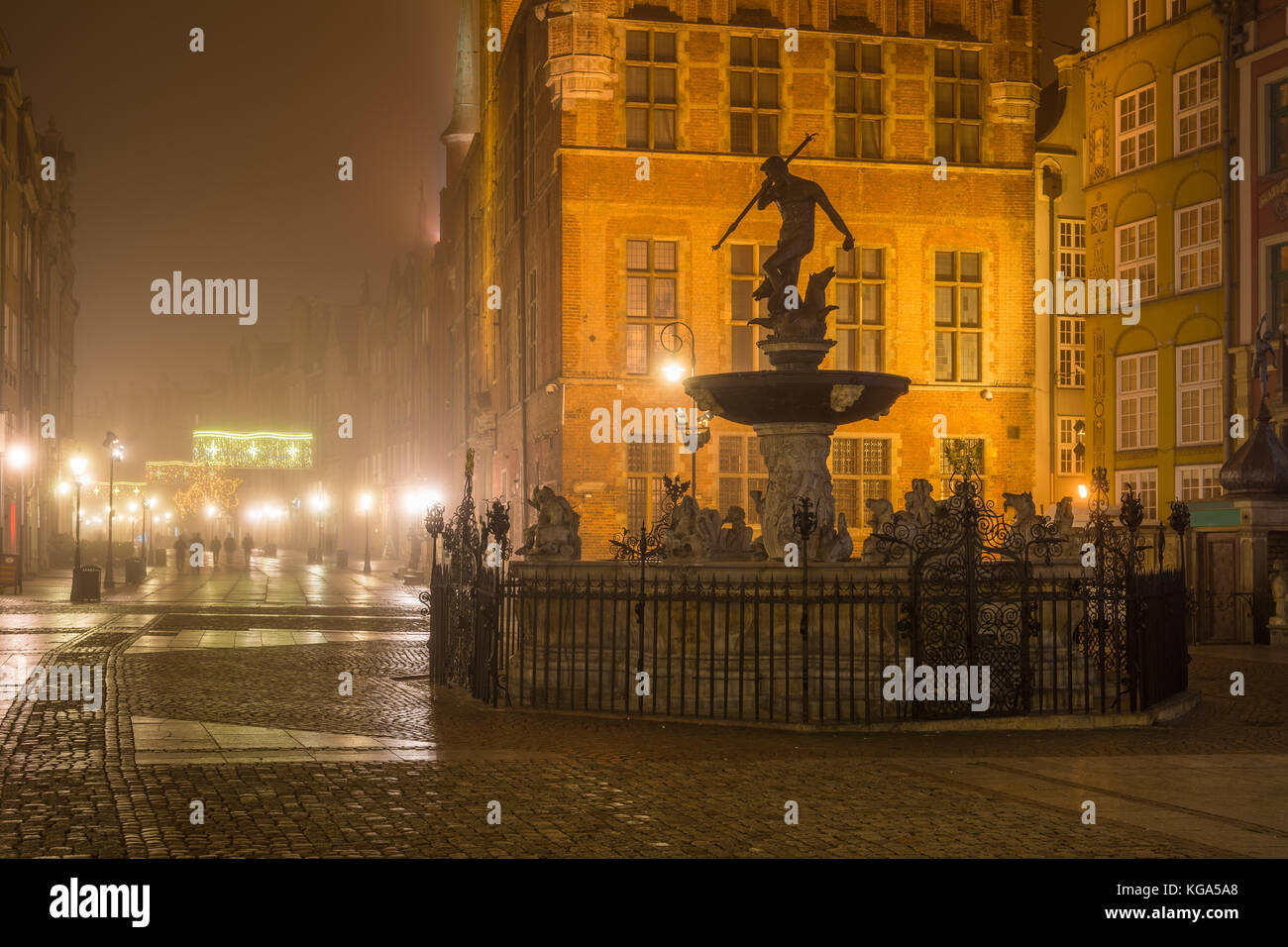 Fountain of the Neptune in Old Town of Gdansk in the fog at night ...