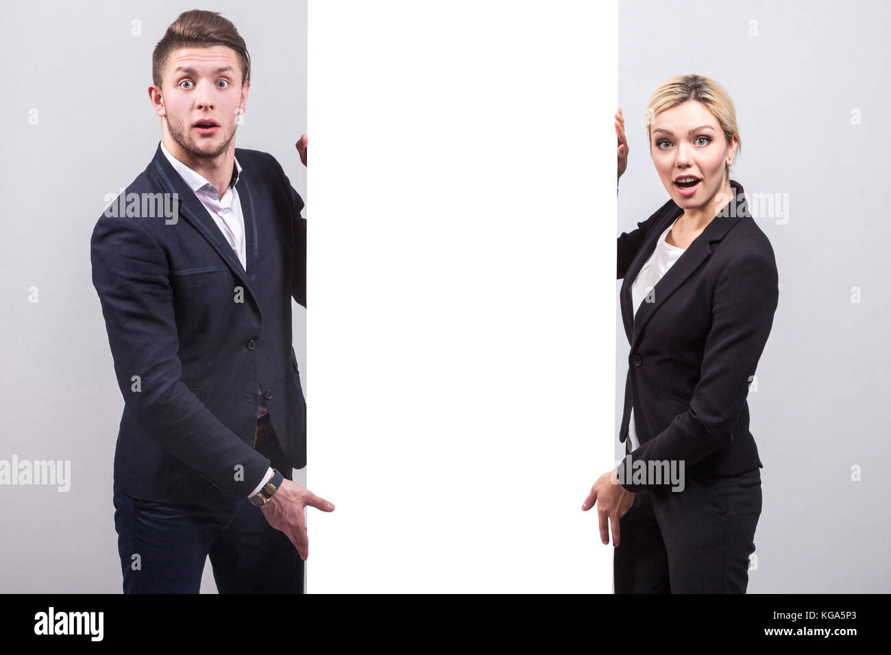 Picture of team of office workers stand near poster Stock Photo - Alamy