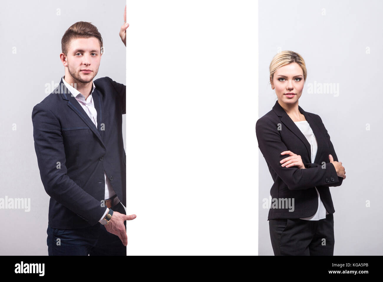 Picture of team of office workers stand near poster Stock Photo - Alamy