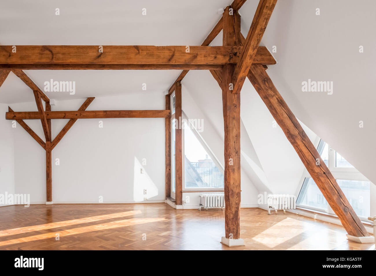 empty loft room with wooden framework and parquet floor Stock Photo - Alamy