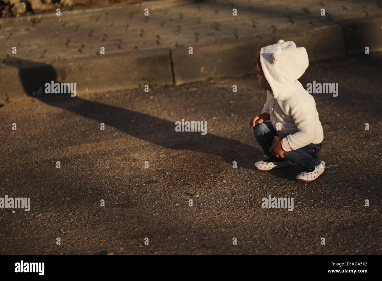 photo of little girl with shadow outdoors Stock Photo - Alamy