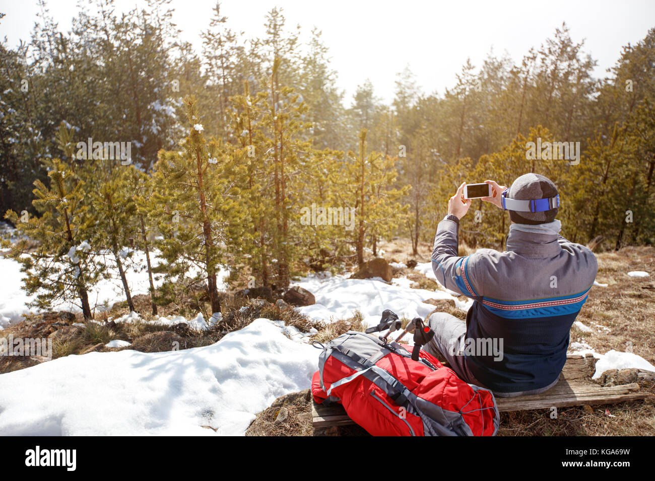 Back view of male hikers taking photo of nature in forest Stock Photo ...