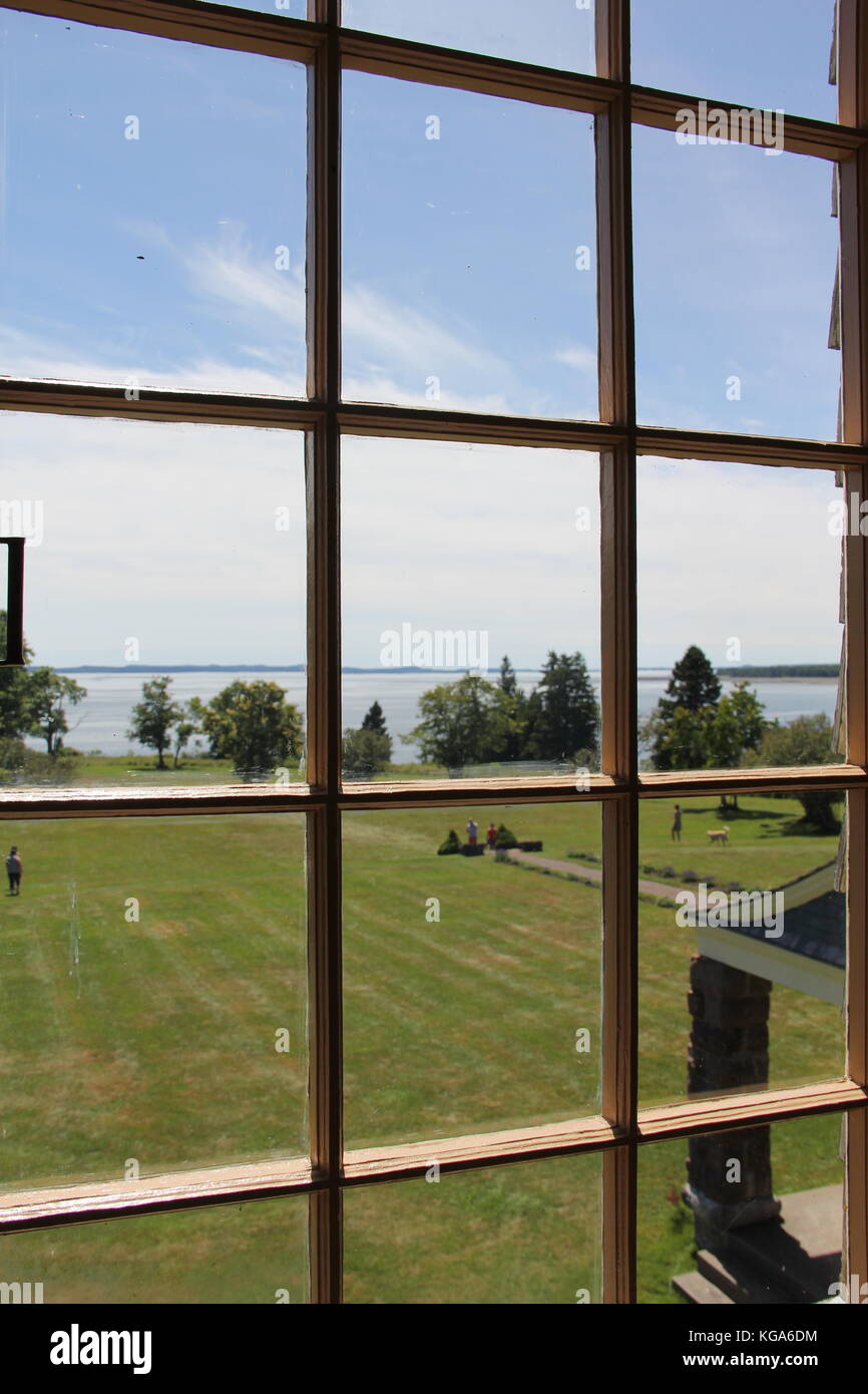 View of an old window on grassy green field and on water Stock Photo ...