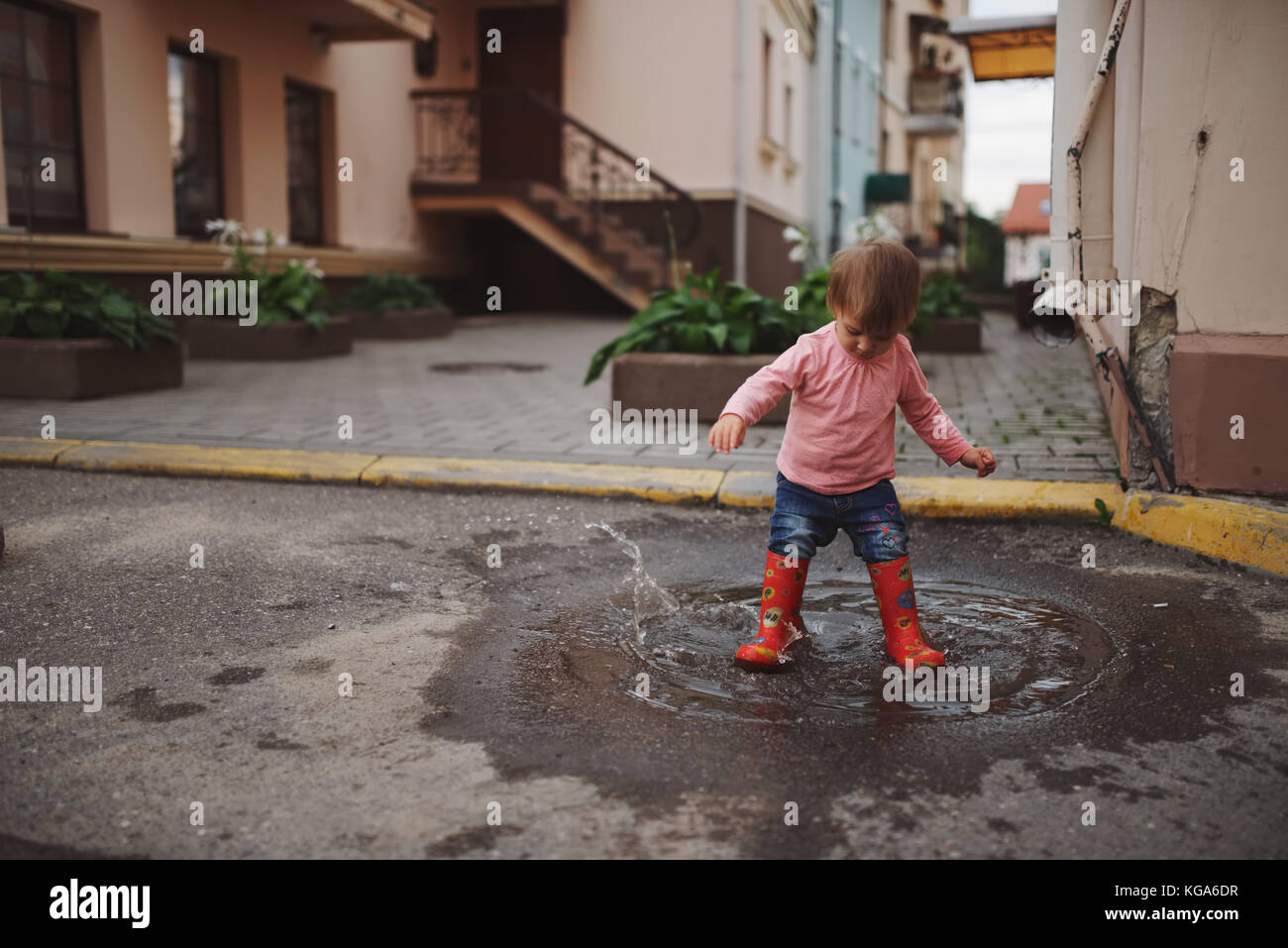 Girl jumping in muddy puddle hi-res stock photography and images - Alamy