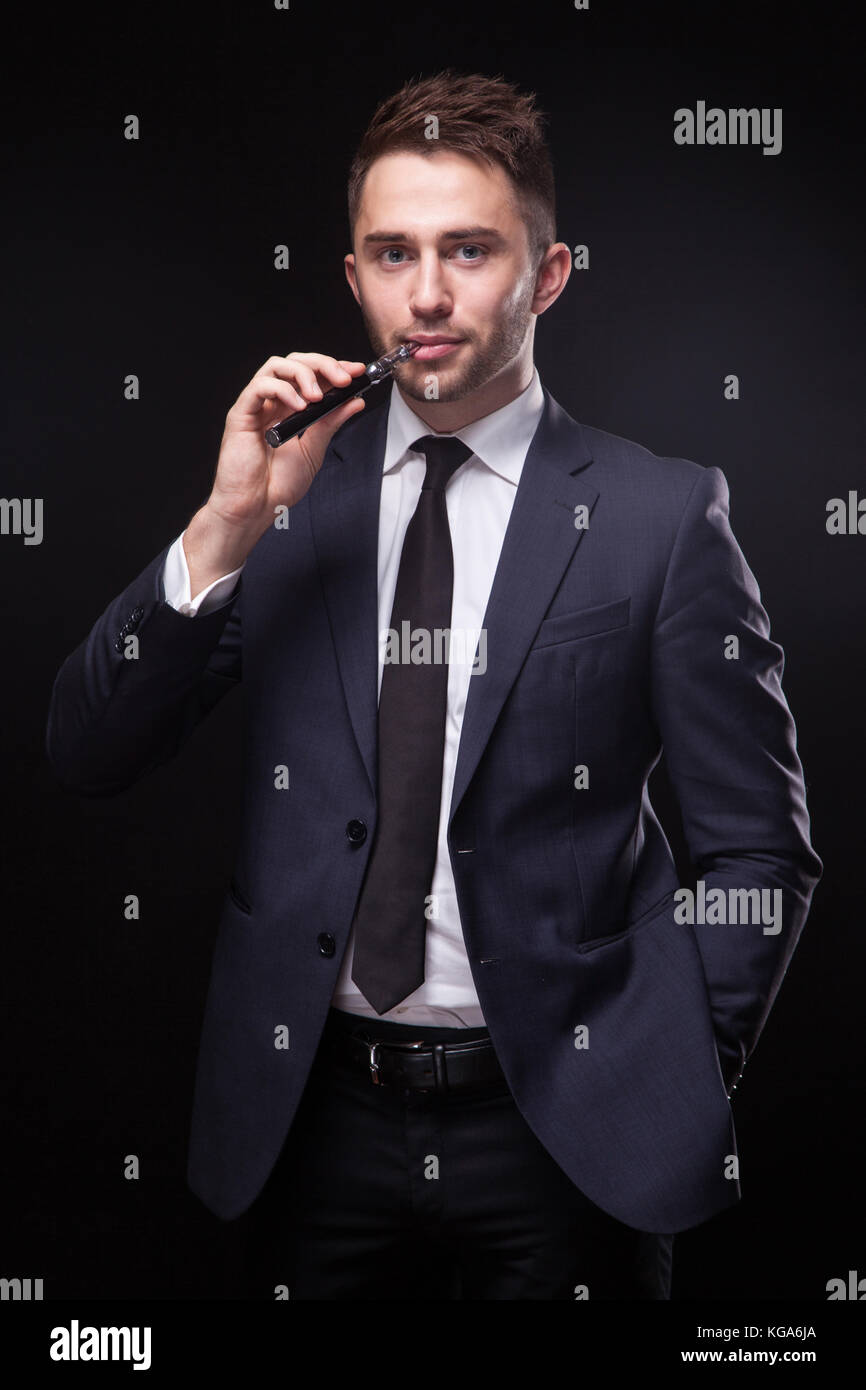 successful young businessman in a stylish business suit on a bla Stock ...