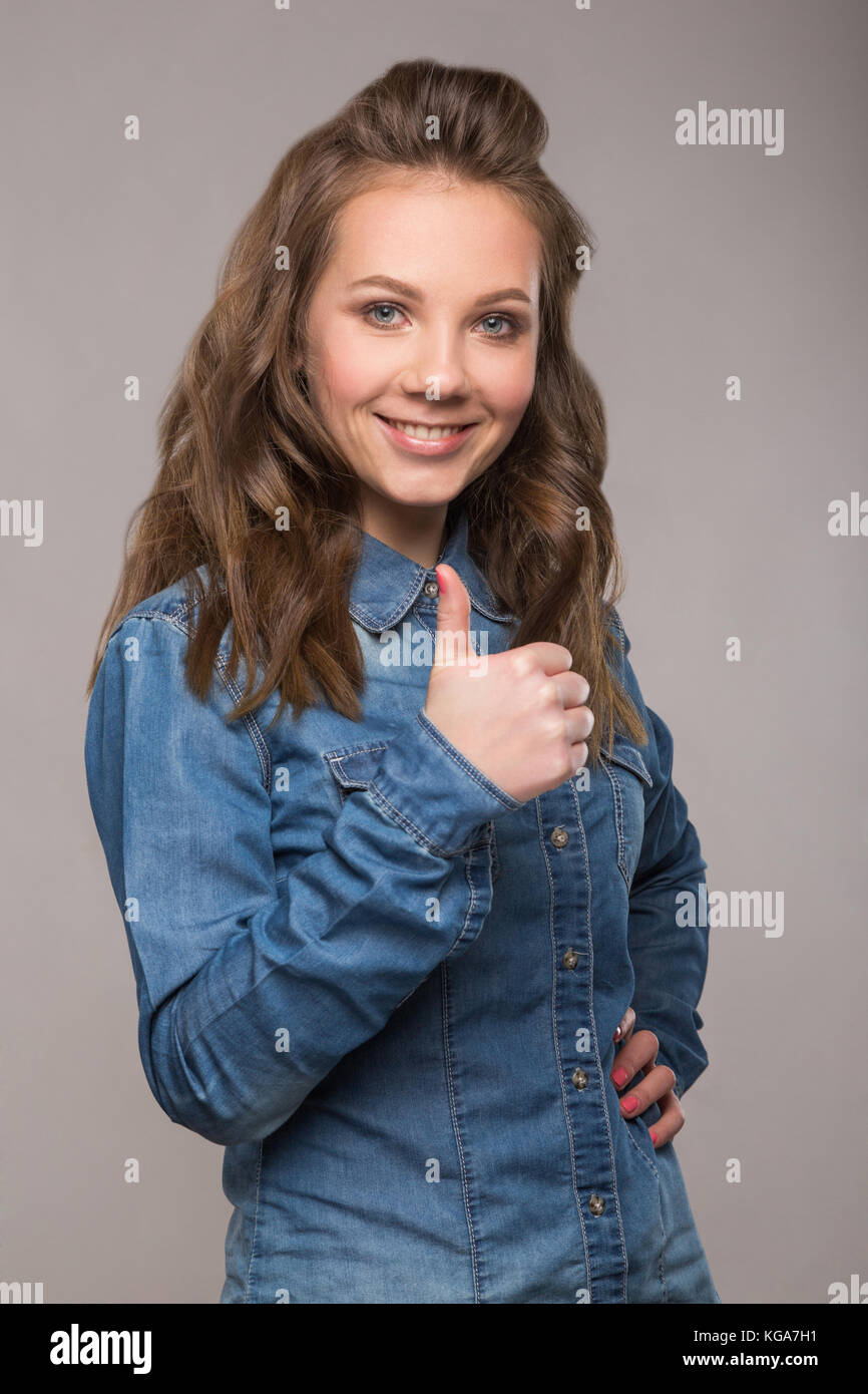 Portrait of energetic fun girl student on a gray background in a Stock ...