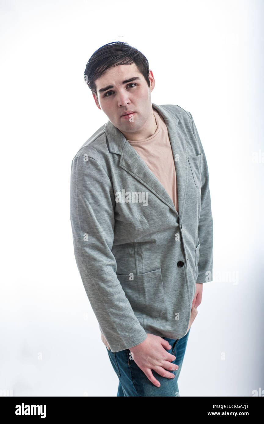 Young fair skinned guy in sports jacket turned and looking over ...