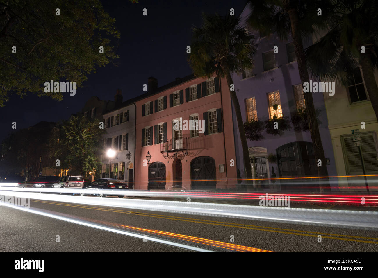 Rainbow row at night with cars going by Stock Photo - Alamy