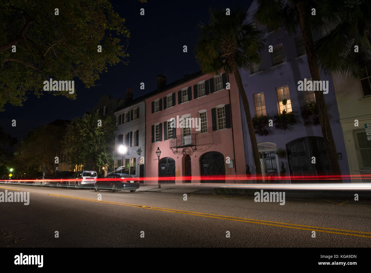 Rainbow row at night with cars going by Stock Photo - Alamy