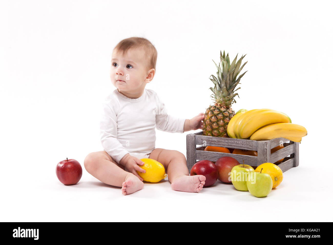 looking at fruit cute smiling baby on white background among fru Stock ...
