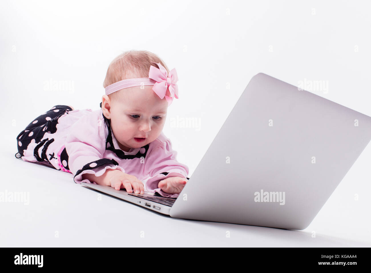 a beautiful little baby girl lying on her stomach in a smart pin Stock ...
