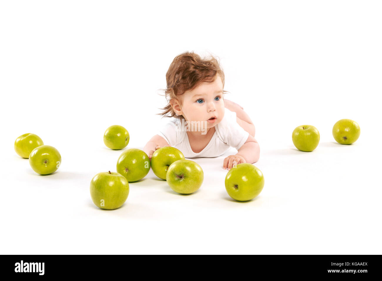 funny baby surrounded by green apples Stock Photo - Alamy