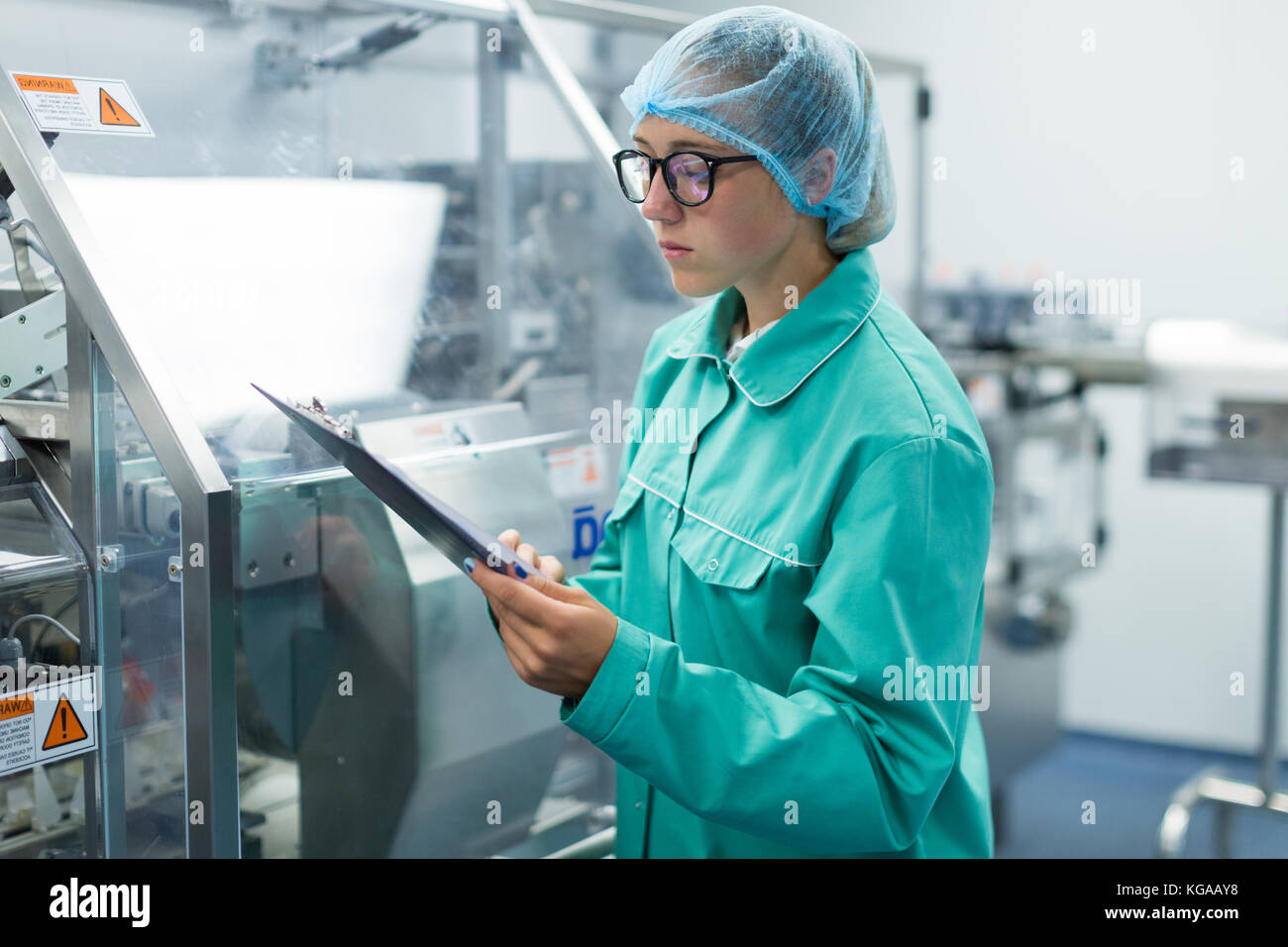 the operator controls the machine in the factory work Stock Photo - Alamy