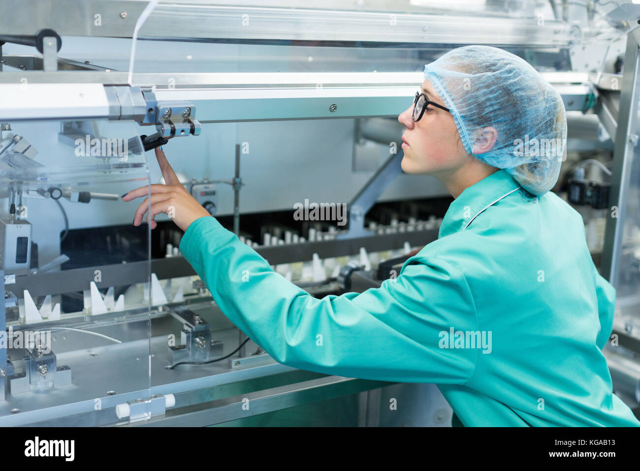 worker operates the machine at the enterprise, clean room with s Stock ...