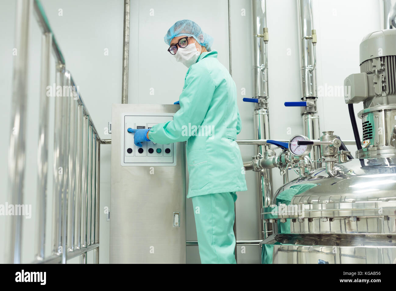 the operator controls the machine in the factory work Stock Photo - Alamy