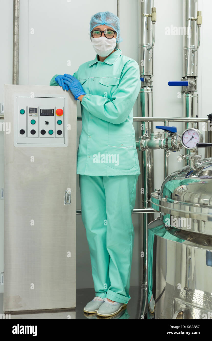 the operator controls the machine in the factory work Stock Photo - Alamy