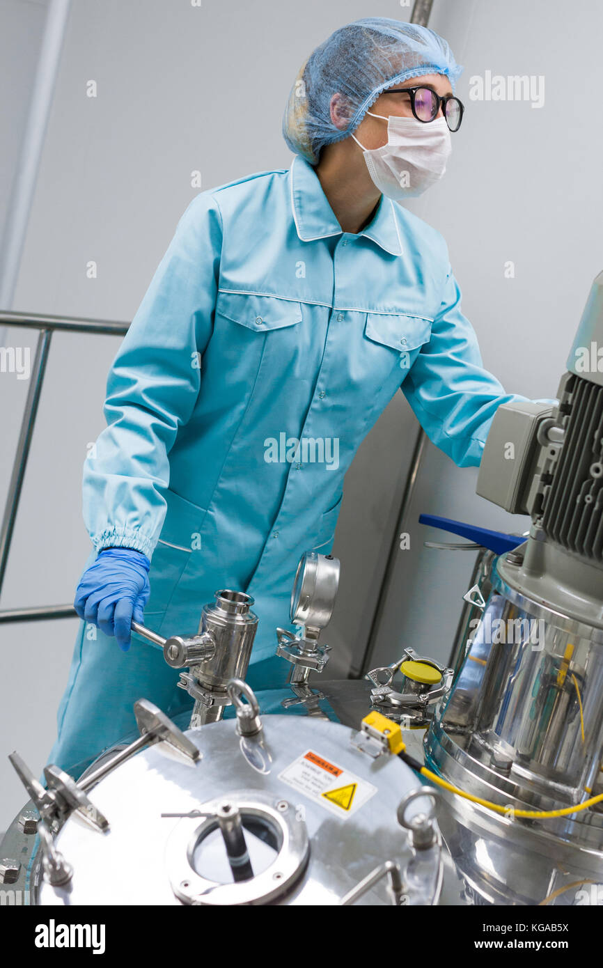 Woman checks factory equipment working hi-res stock photography and ...