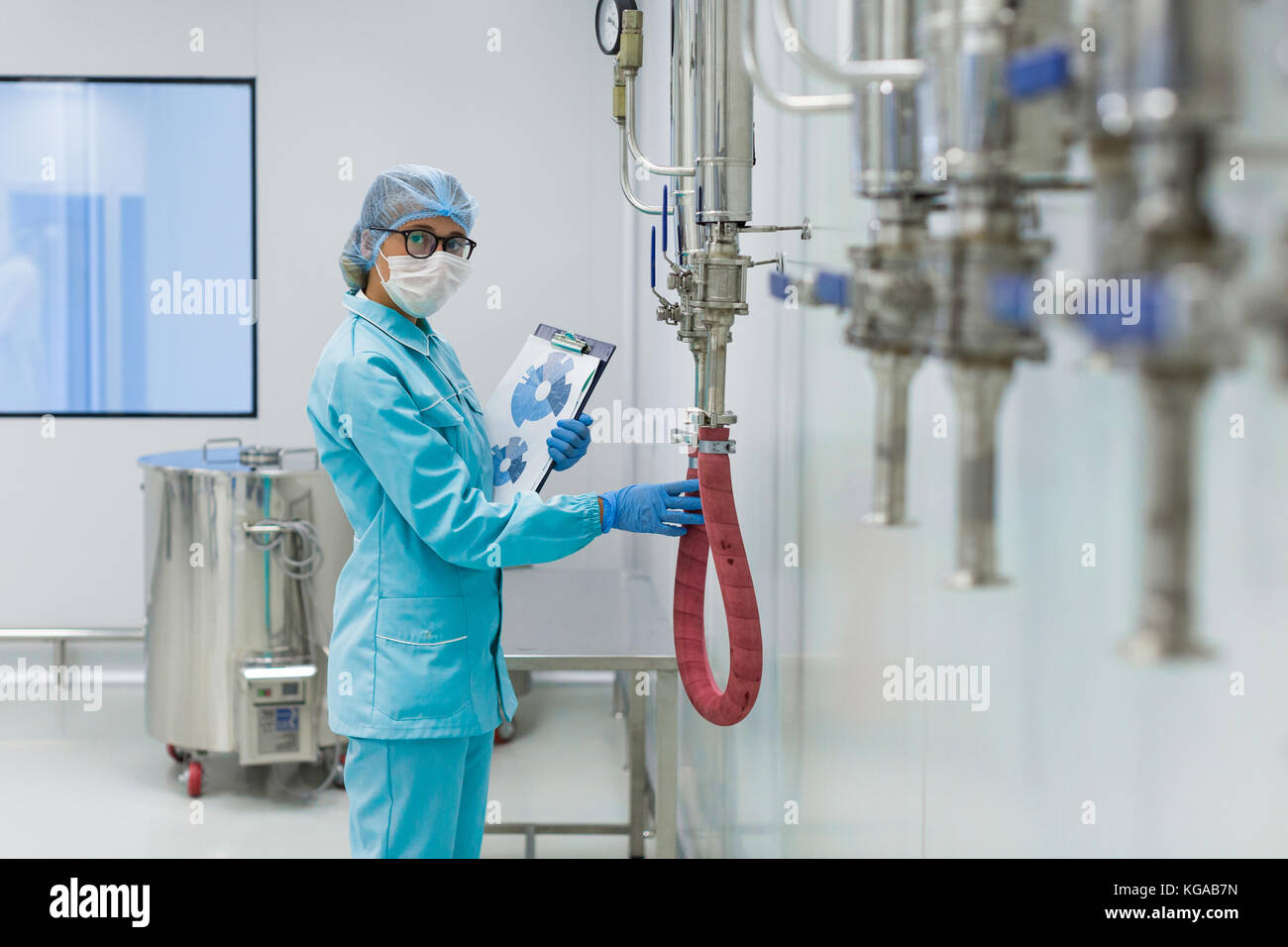 Woman checks factory equipment working hi-res stock photography and ...
