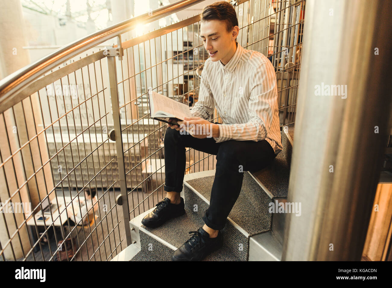 Student read his book on the steps to library with sun light Stock ...