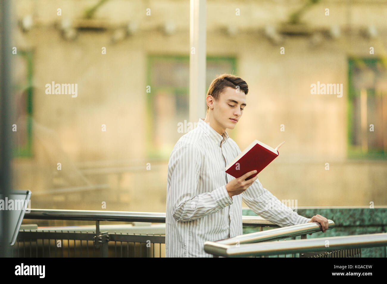 Man stsnd on the library and read book with blur background sun light ...