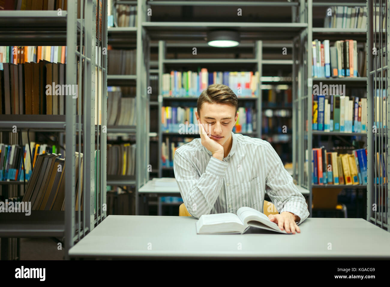 Man sit on the library and read book with blur background Stock Photo ...