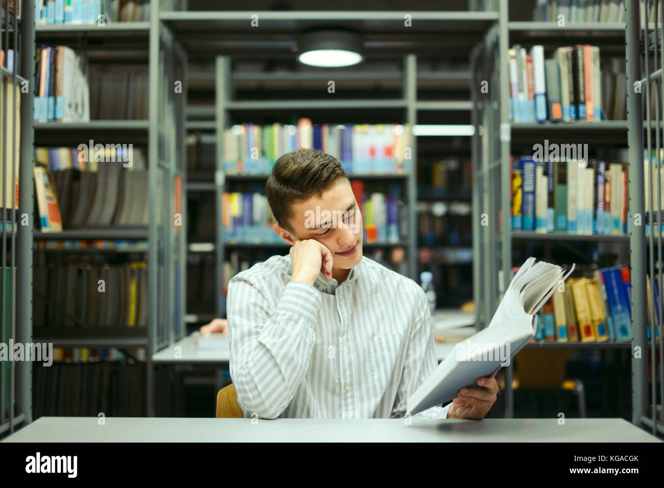 Man sit on the library and read book with blur background Stock Photo ...