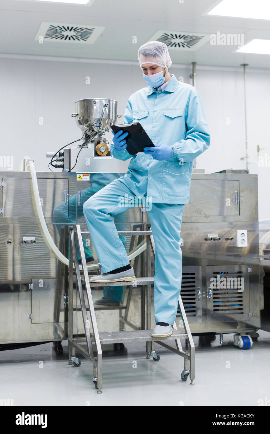 scientist work with big metal machine on ladder Stock Photo - Alamy