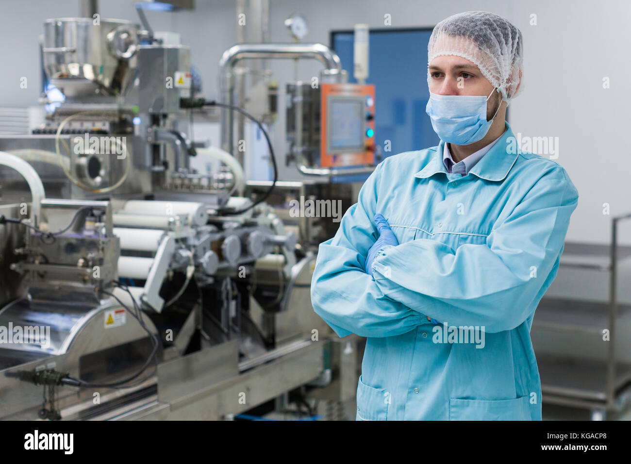 plant picture, factory worker is standing near machine, steel ma Stock ...