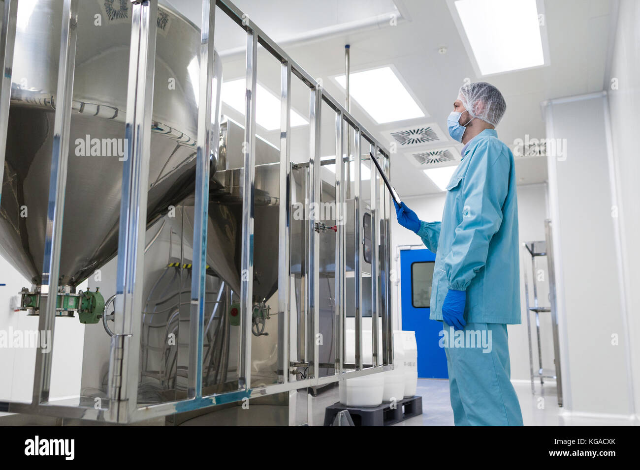 scientist stand near chromed barrels Stock Photo - Alamy