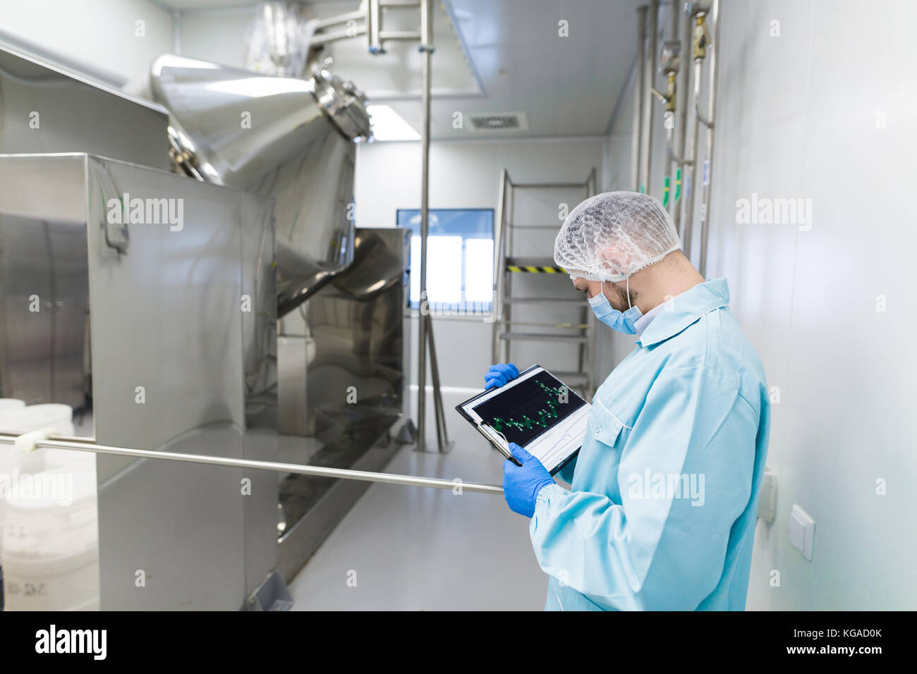 scientist stand near chromed barrels Stock Photo - Alamy