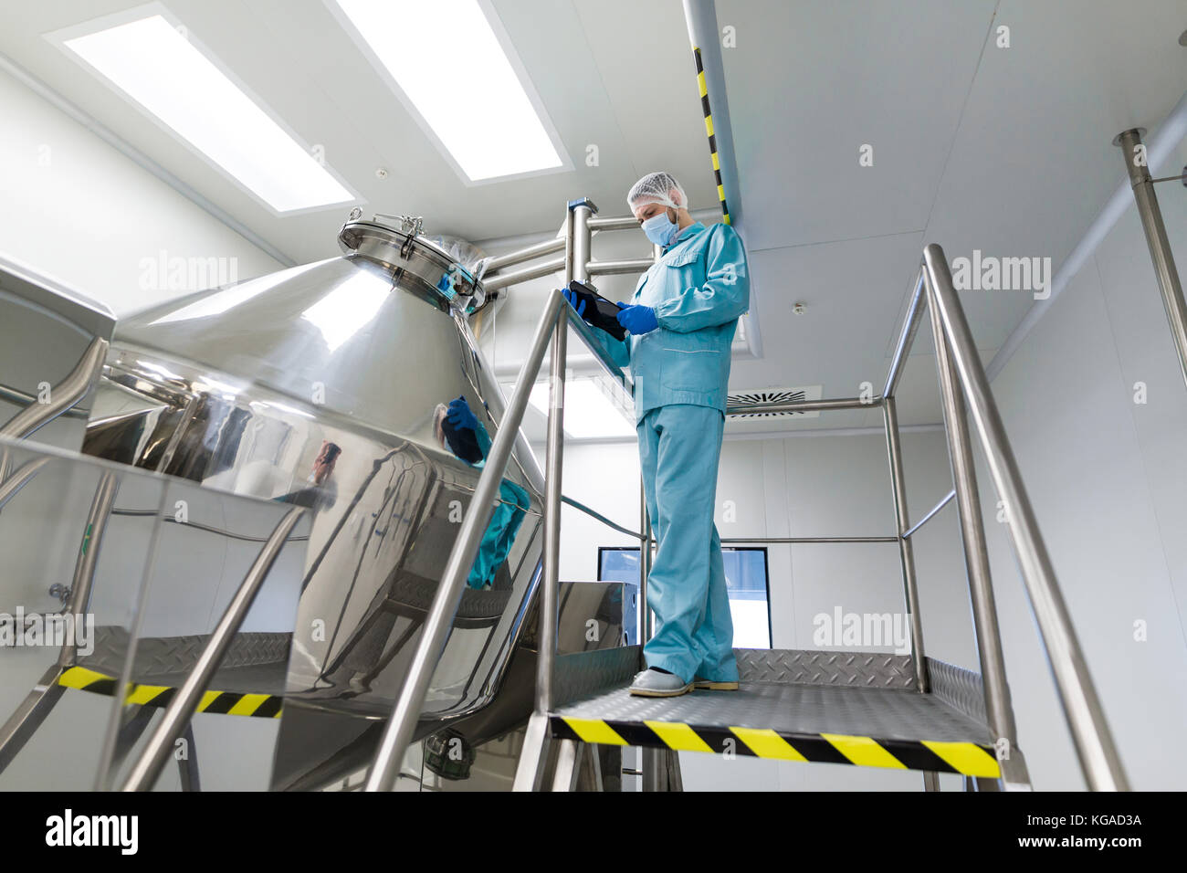 scientist make notes about big metal tank Stock Photo - Alamy