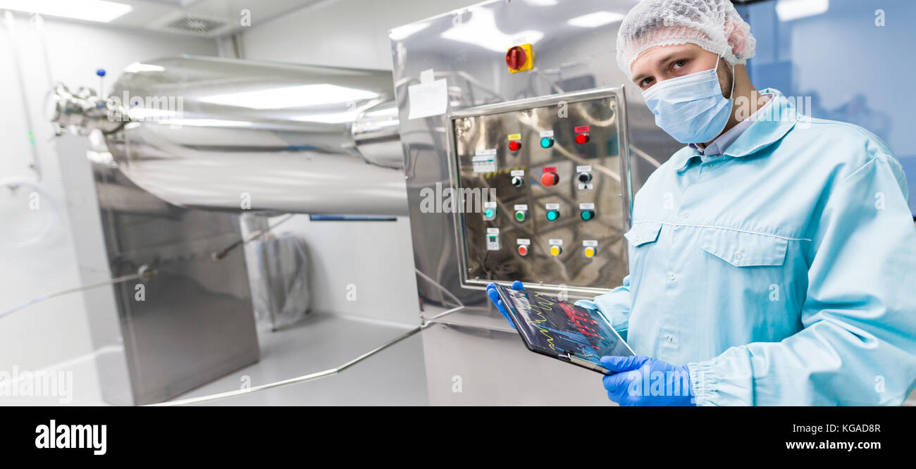 widescreen picture, factory worker is checking control panel on Stock ...