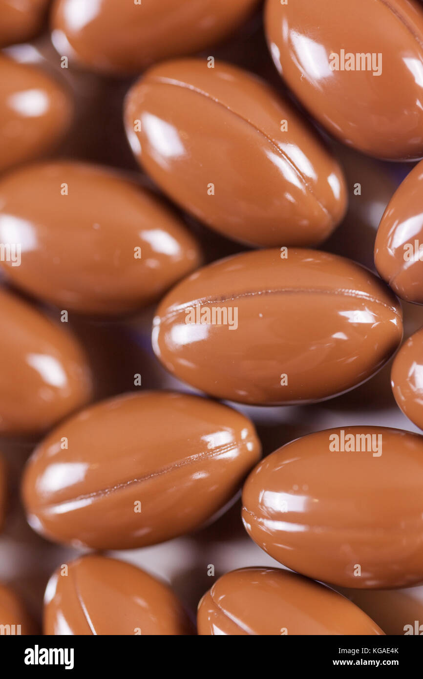 a scattering of brown capsules, tablets on a mirrored background Stock ...