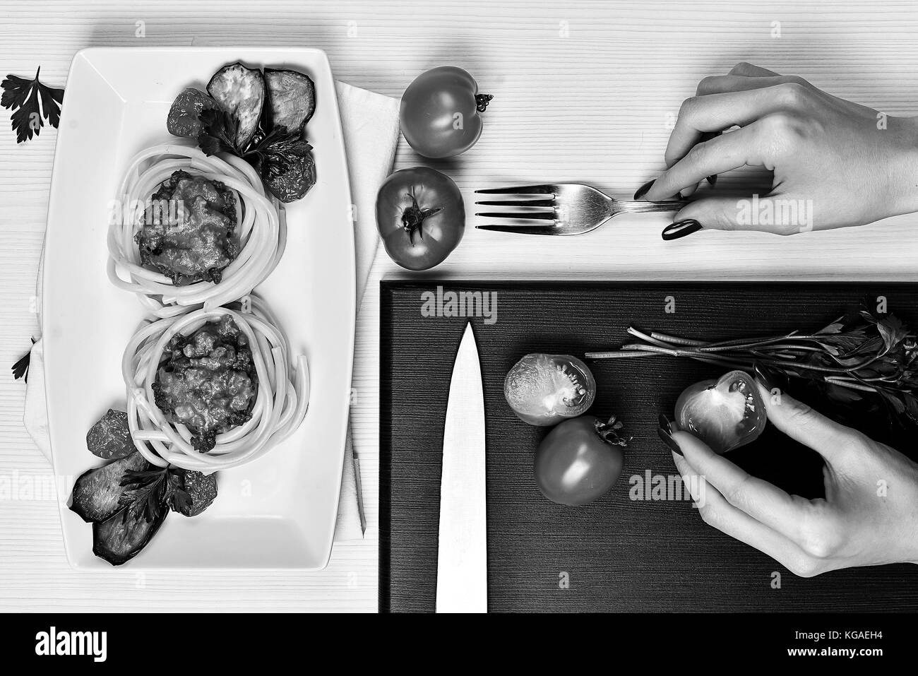 Dinner in the restaurant. Hands plates of food. Fork for eating Stock ...