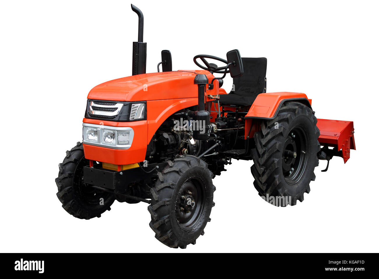 Red compact tractor with attached cultivator Stock Photo - Alamy