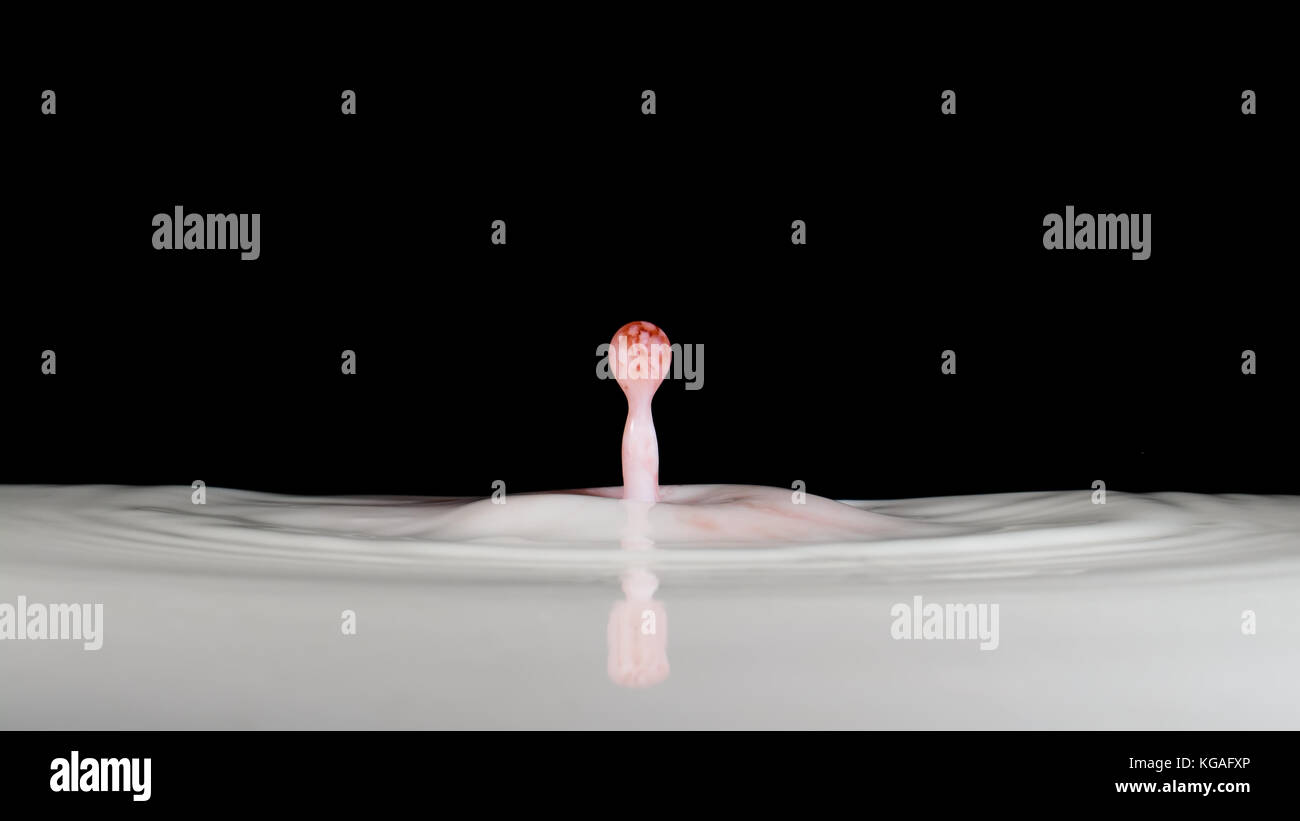 Cherry juice drop splash in milk Stock Photo - Alamy