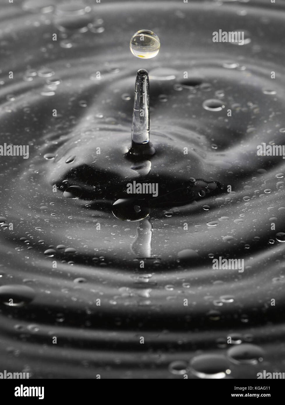 Oil drop splash in water Stock Photo - Alamy